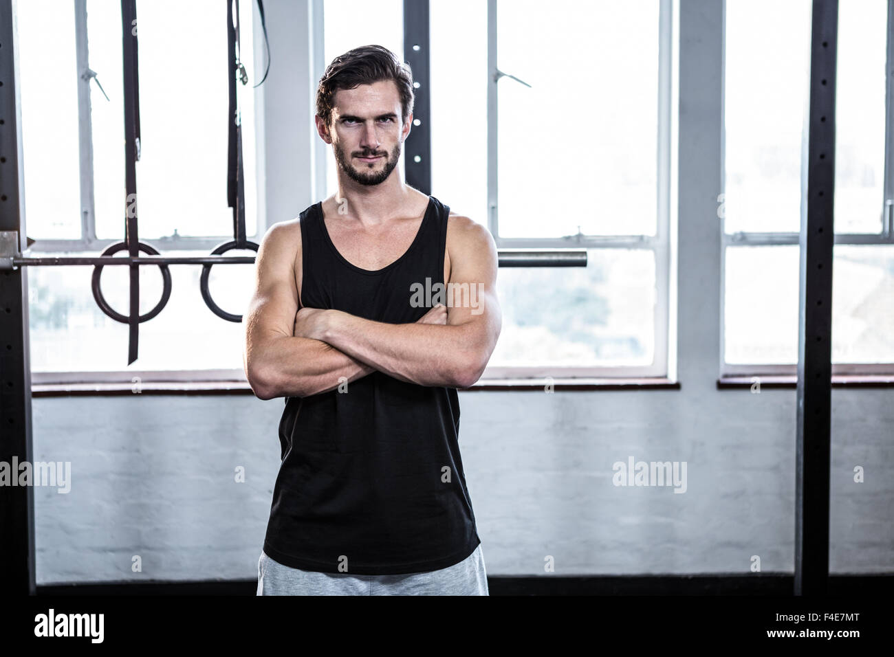 Fit man with arms crossed Stock Photo - Alamy