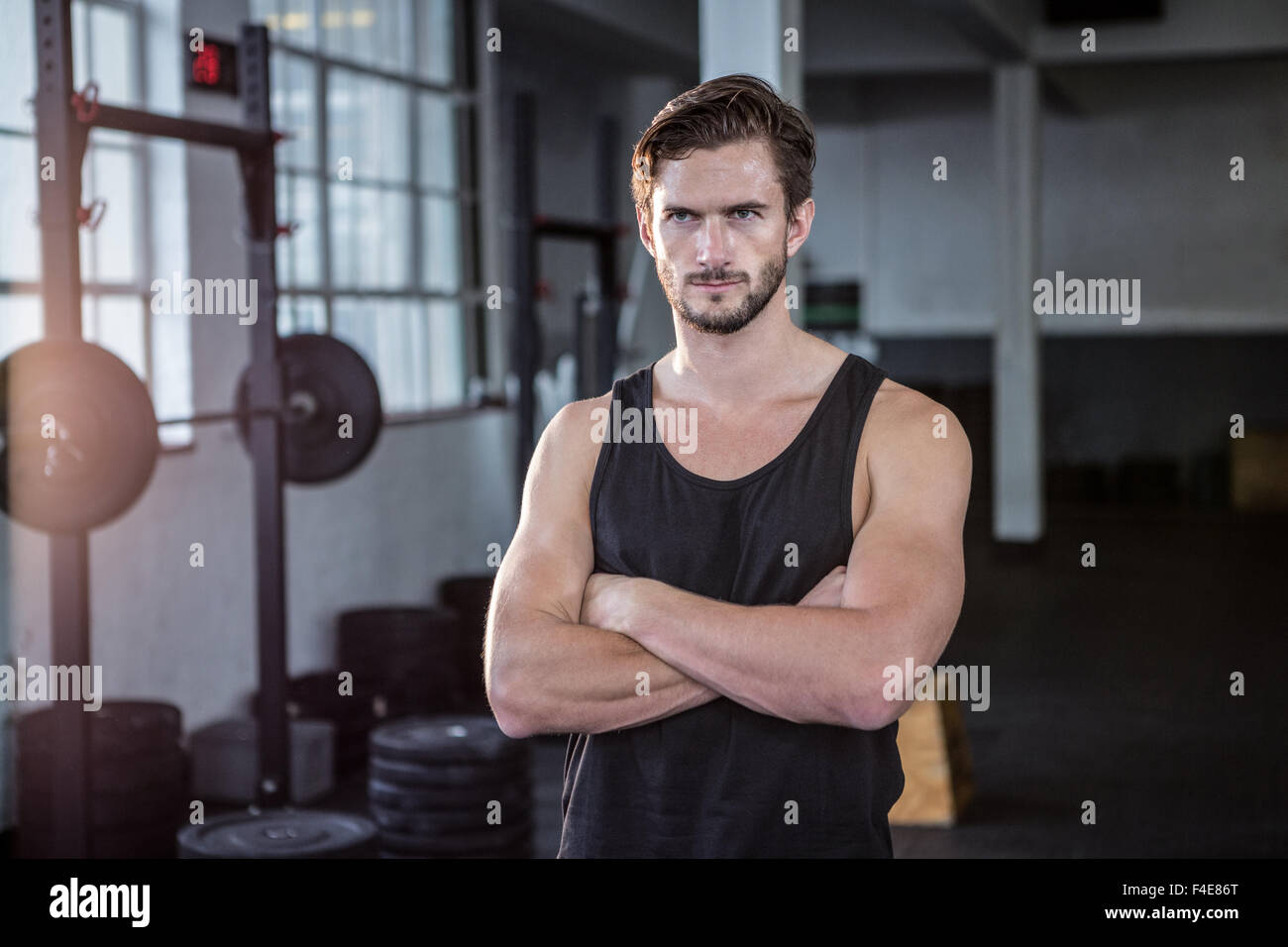 Fit man with arms crossed Stock Photo - Alamy