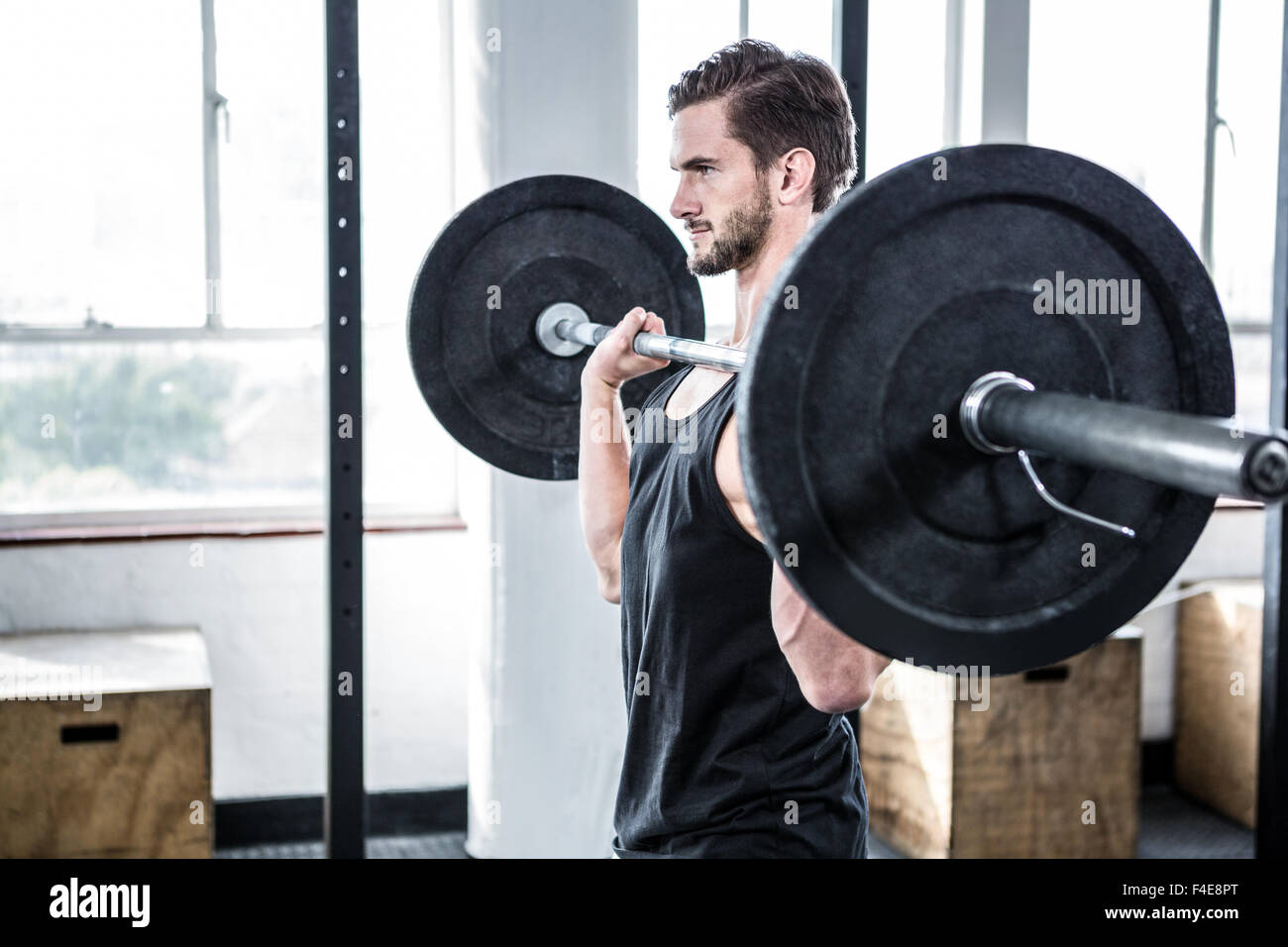 Fit man lifting heavy barbell Stock Photo - Alamy