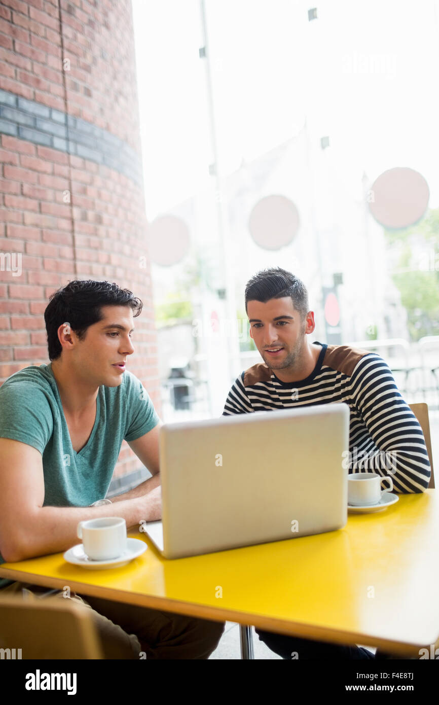 Young man in casual chatting using laptop hi-res stock photography and ...