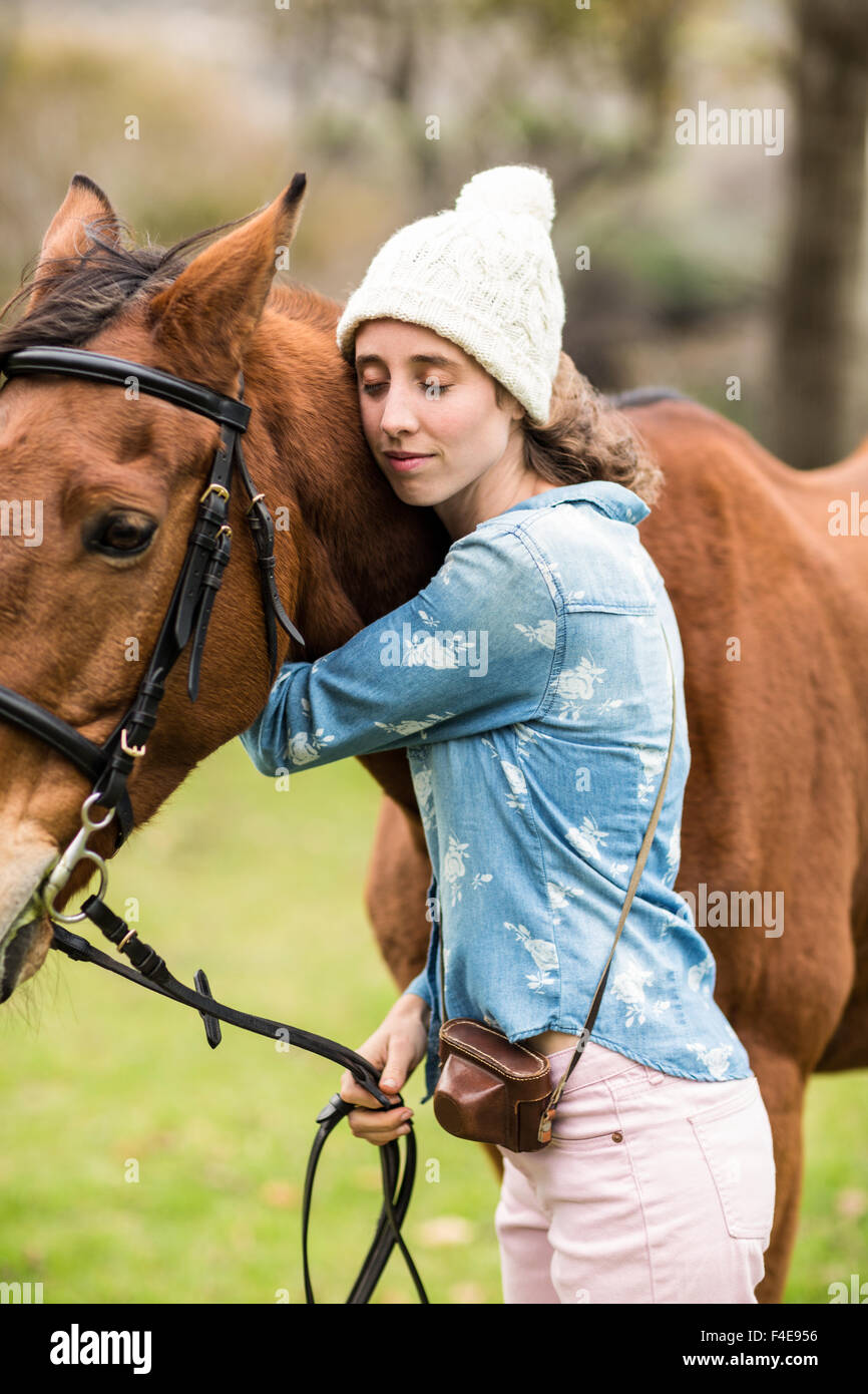 Young woman hugging her horse Stock Photo - Alamy