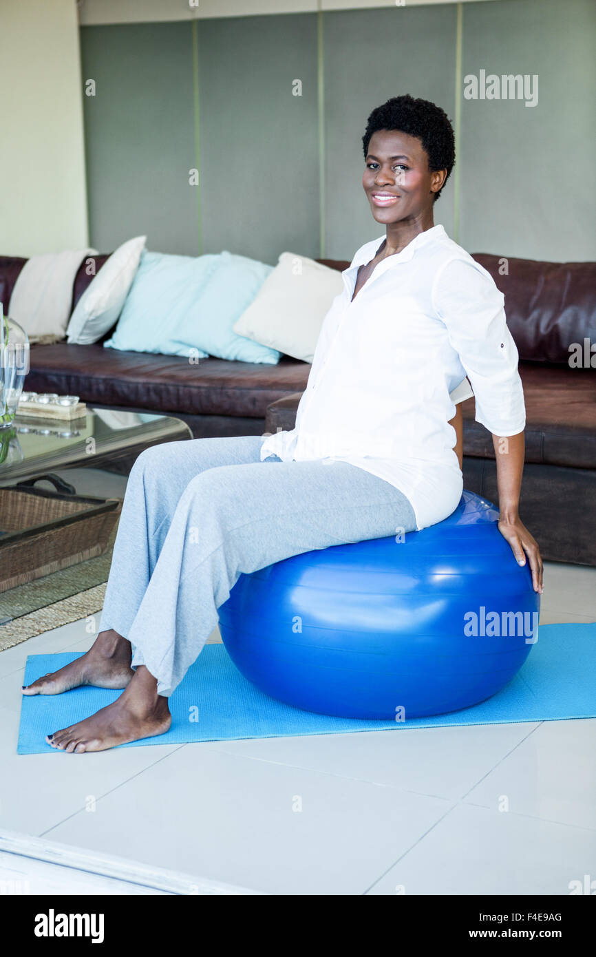 Woman sitting on exercise ball Stock Photo - Alamy