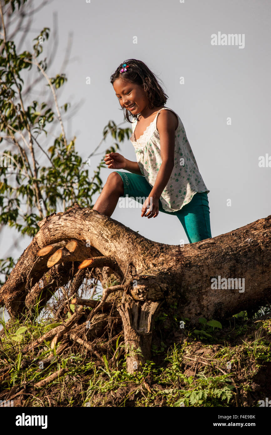 Girl climbing tree root, Amazon basin, Peru Stock Photo - Alamy