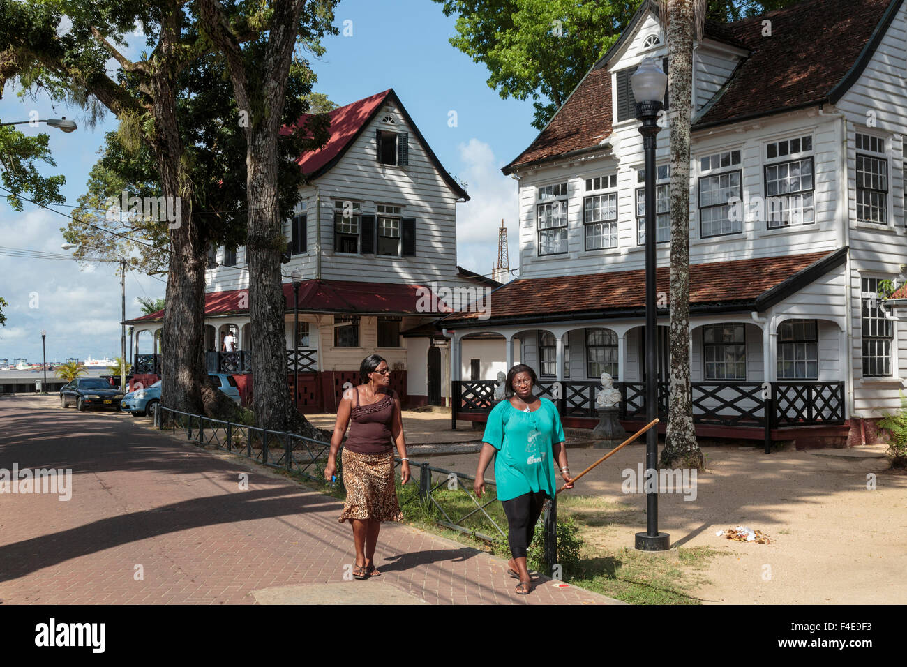 South America, Suriname, Paramaribo. Women walking down road at Fort ...