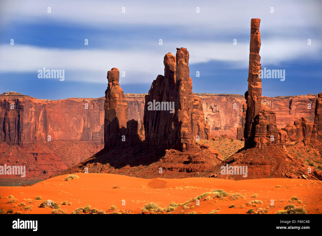 Utah, Monument Valley. Spires of red rock with a sand dune Stock Photo ...