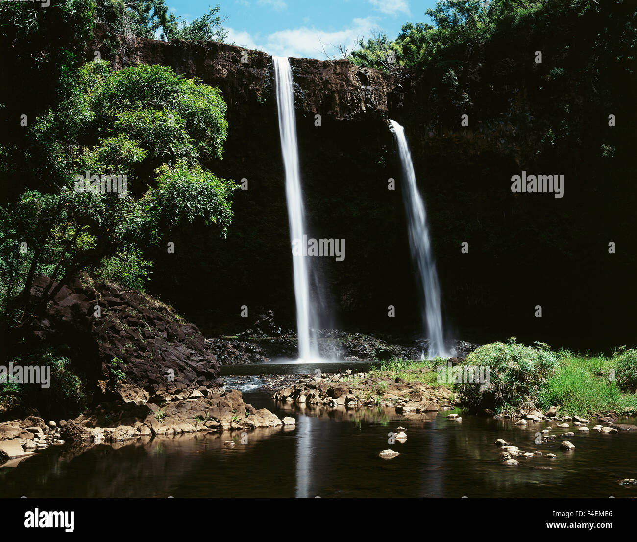 Hawaii, Kauai, Wailua Falls drop from a cliff in the rainforest. (Large ...