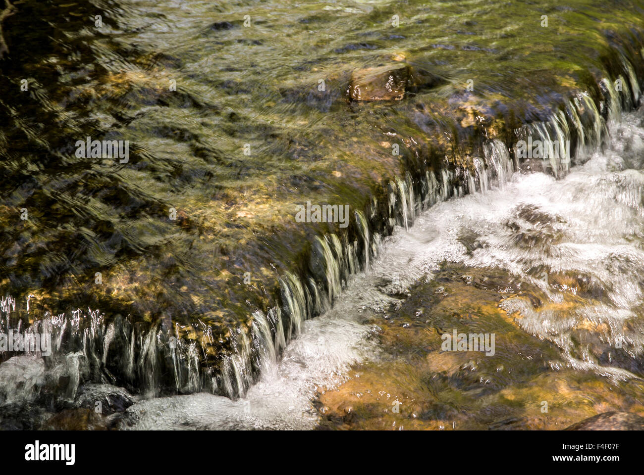 USA, New Jersey, Rockaway Stream, water falling over concrete ...