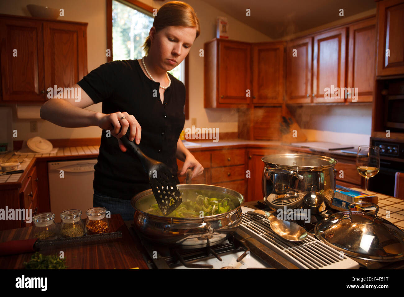 USA, Oregon, Eugene, young woman stirring dinner (MR Stock Photo - Alamy