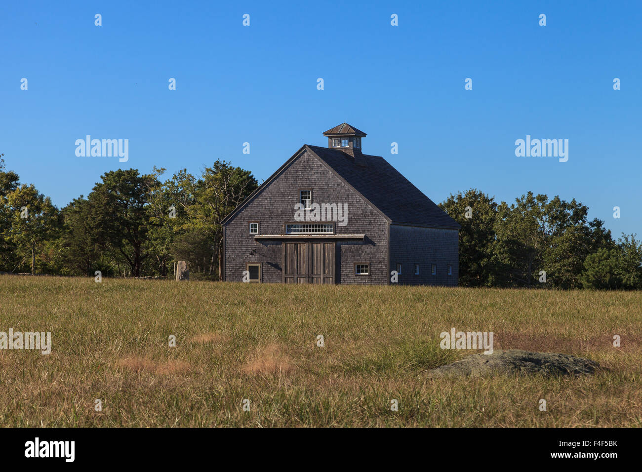 New England rustic barn in summer with a green grass lawn Stock Photo ...