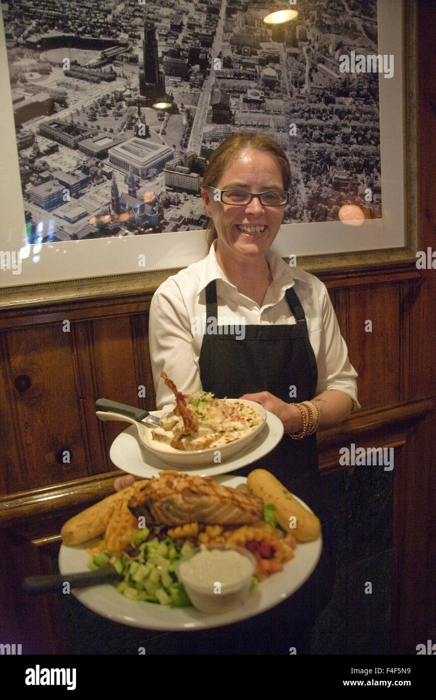 Smiling food server with popular Pitt grilled salmon dishes, Pittsburgh ...