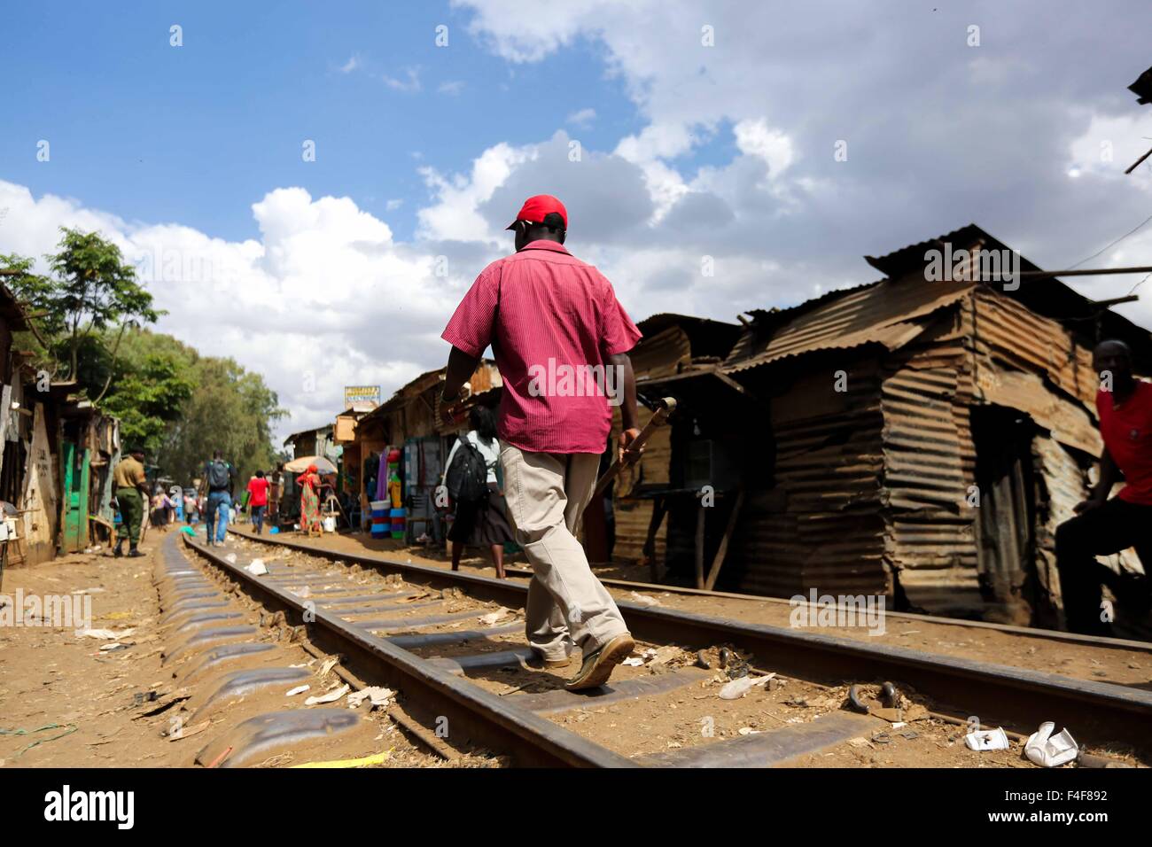 Nairobi, Kenya. 16th Oct, 2015. A man walks along a railway in Kibera ...