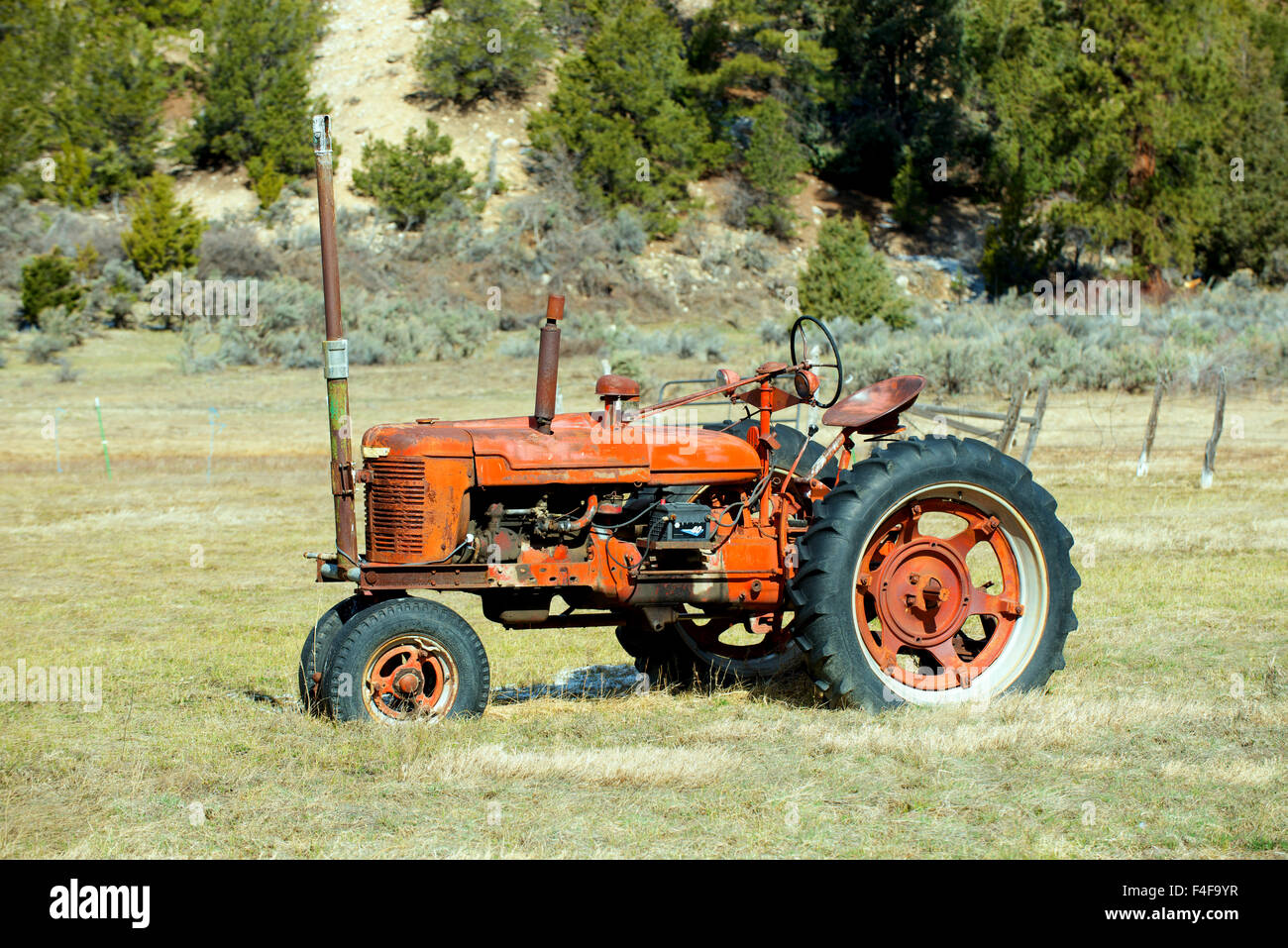 A derelict tractor sits in a deserted field beside Highway 12 in the ...