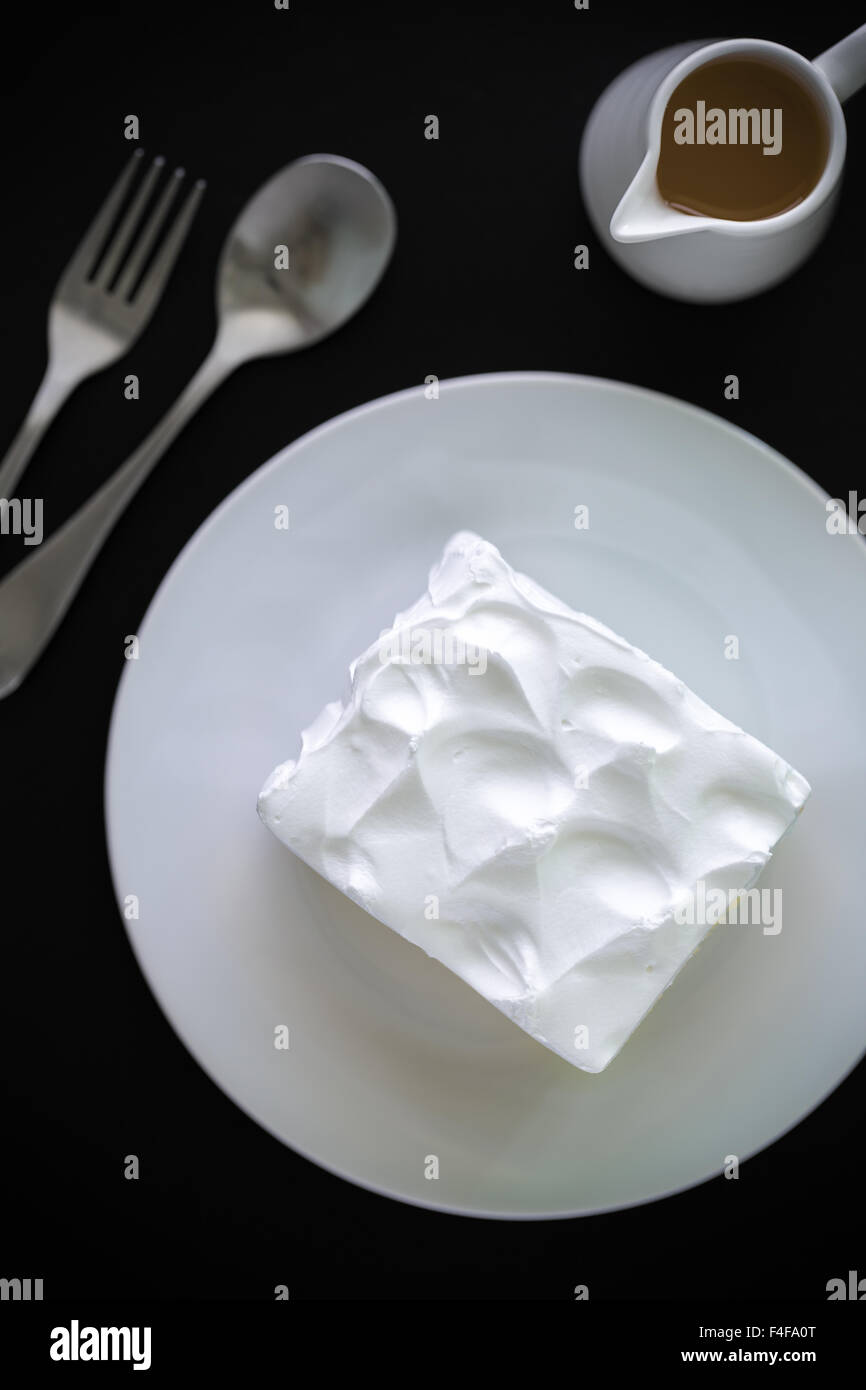 White cake for tea break moment on black background Stock Photo - Alamy