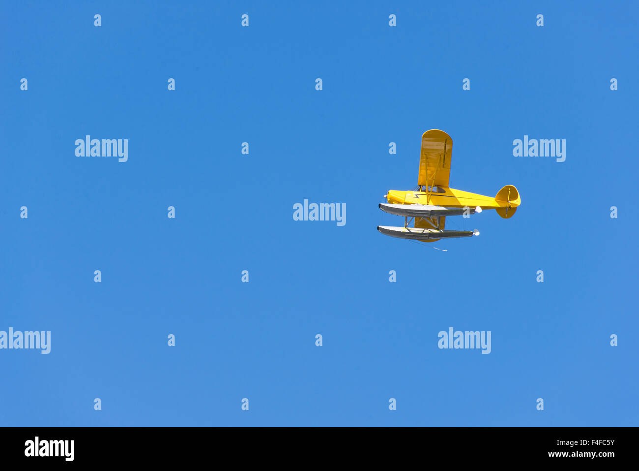 USA, Washington State, Puget Sound. Colorful float plane flies overhead ...