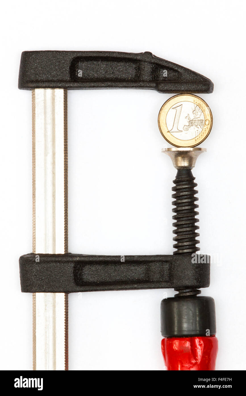 Euro coin squeezed in a clamp Stock Photo - Alamy