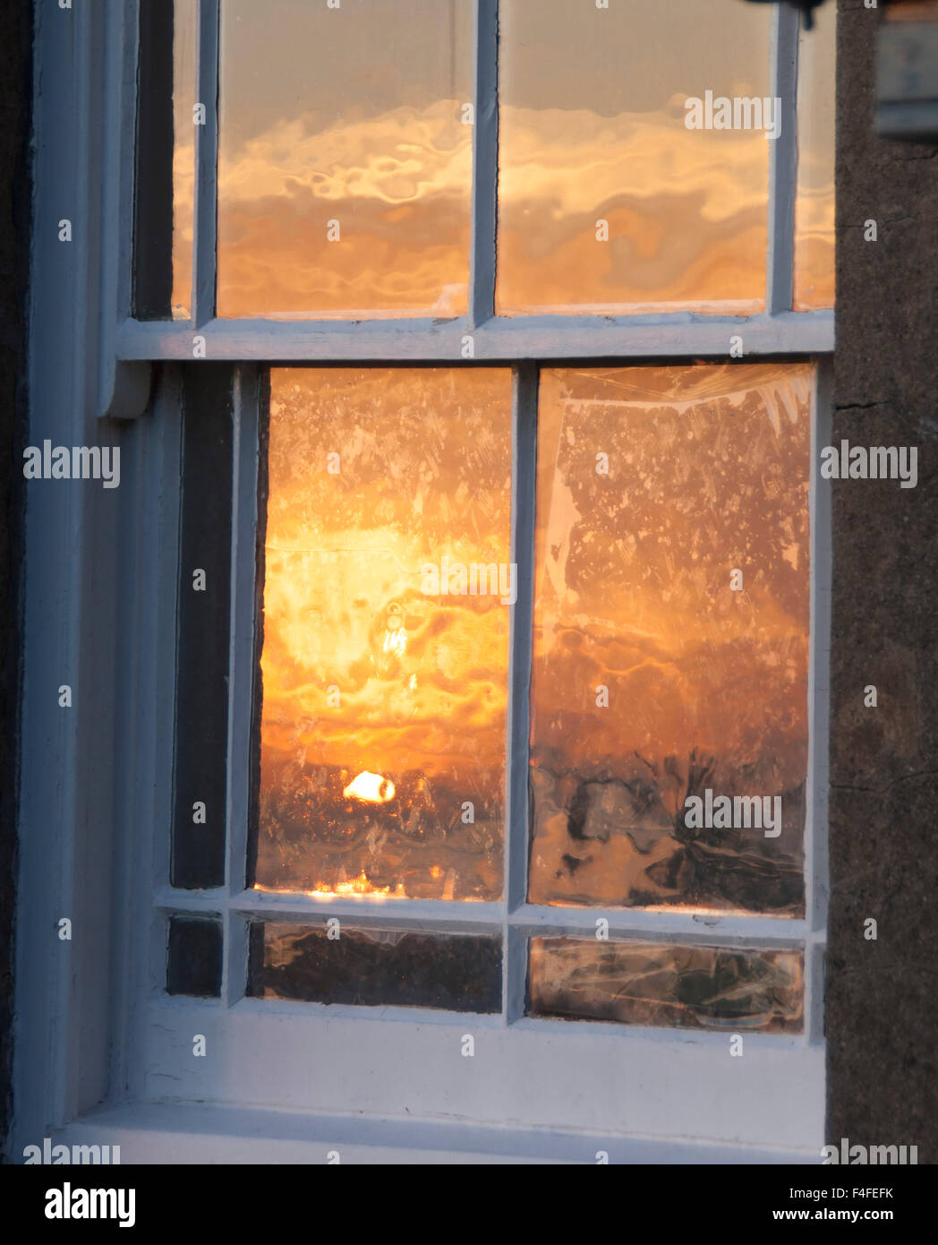 Sunset reflected in window Wales UK Stock Photo - Alamy