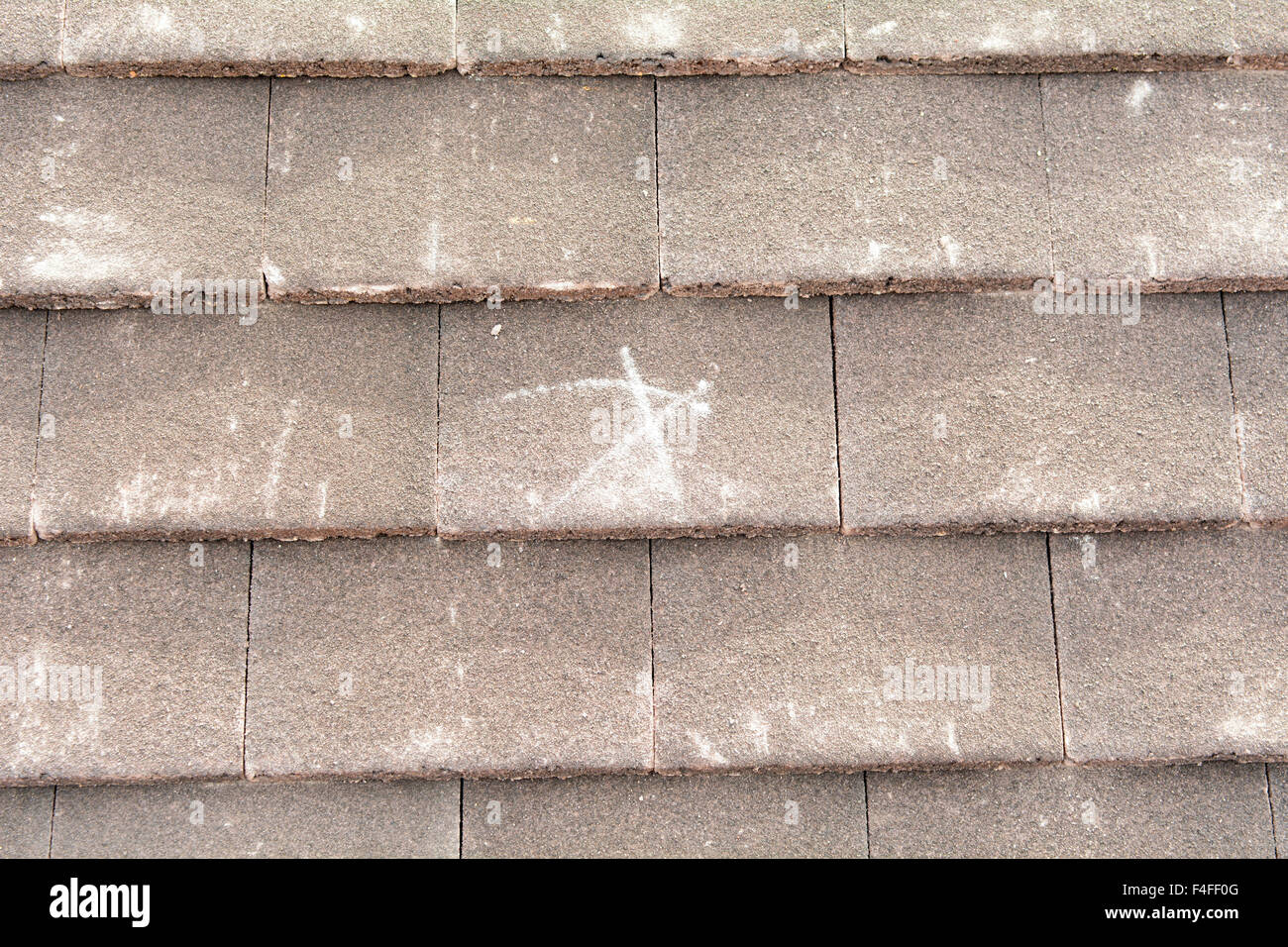X mark on roof tiles to signify row of tiles to nail to wooden battens ...