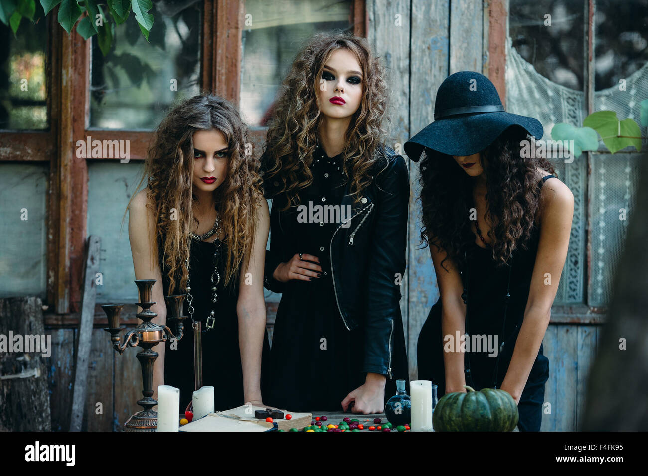 three witches at the table on the eve of Halloween Stock Photo - Alamy