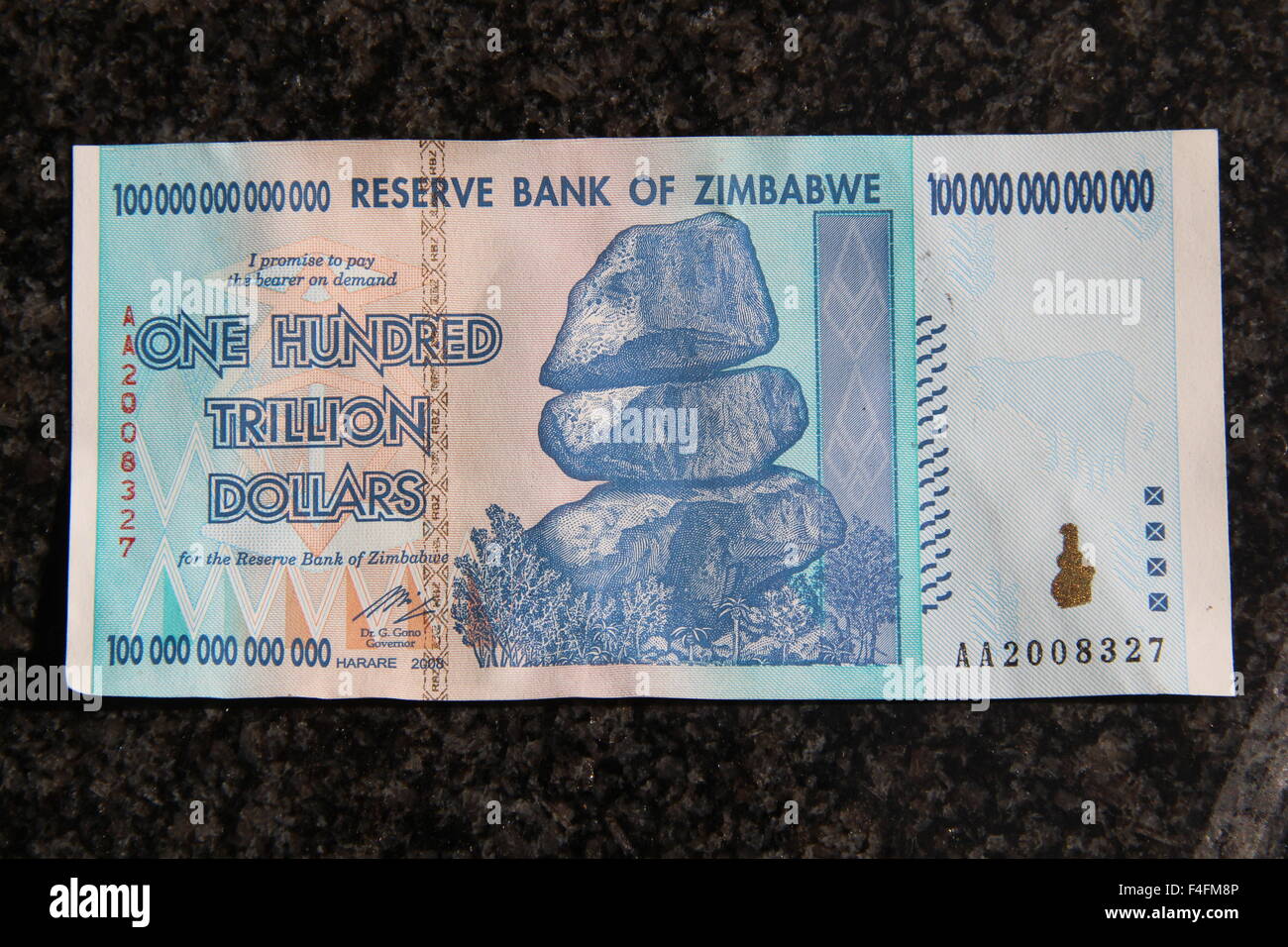 A banknote from Zimbabwe worth one hundred trillion Zimbabwean dollars ...