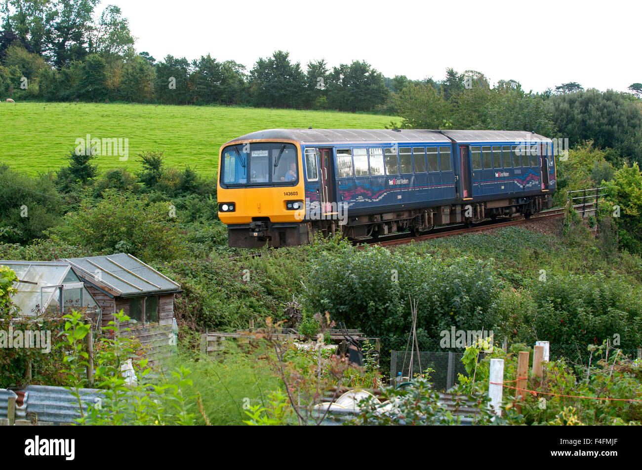 Pacer class 143 train passes allotments on the Avocet Line,Devon, UK ...