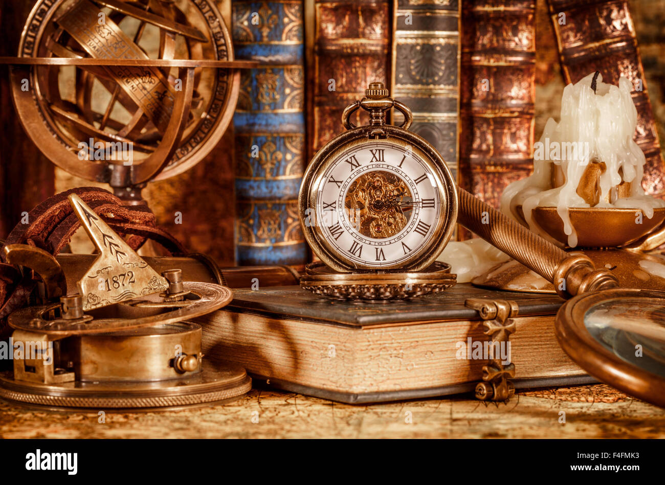 Vintage book, compass, telescope and a pocket watch lying on ancient ...