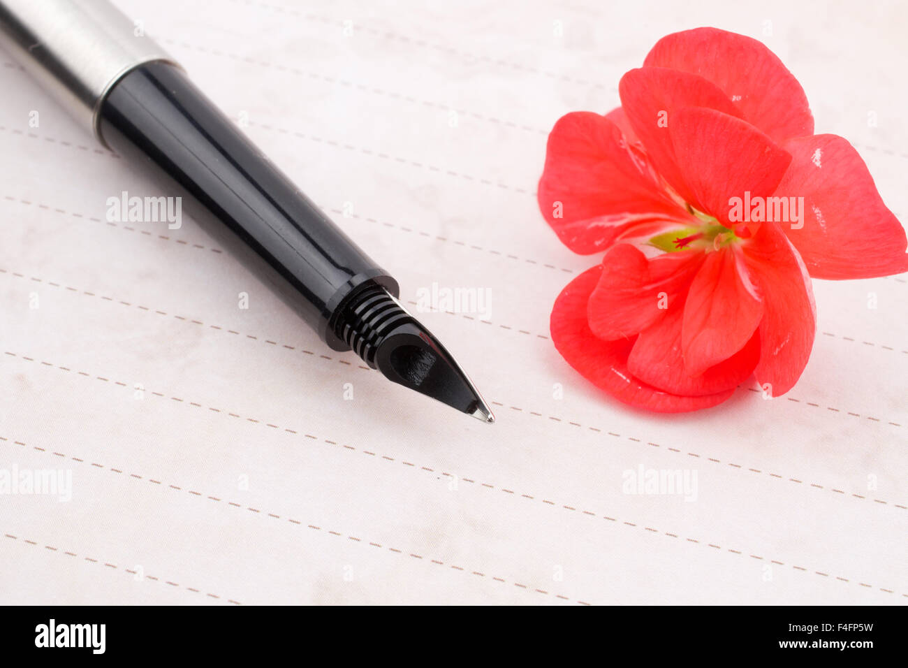 Notebook, pen and flower Stock Photo - Alamy