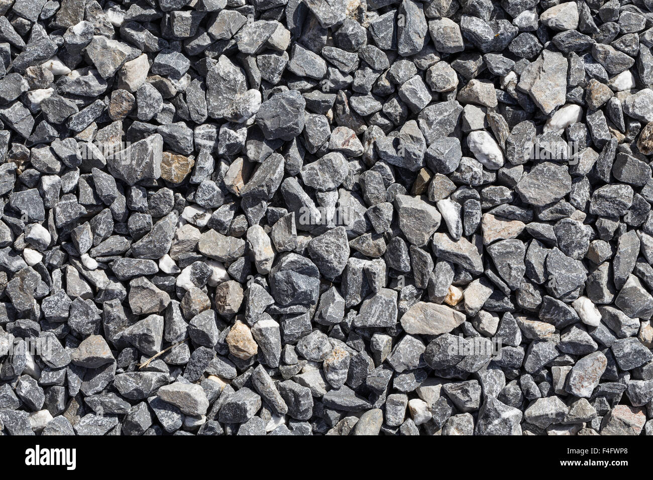Crushed grey stone on the ground texture background Stock Photo - Alamy