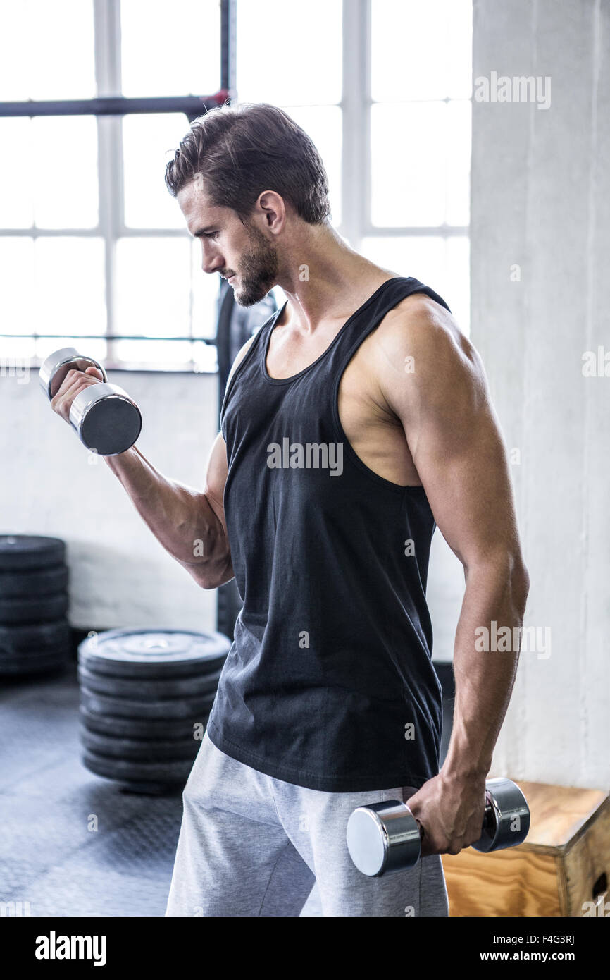 Fit man working out with dumbbell Stock Photo - Alamy