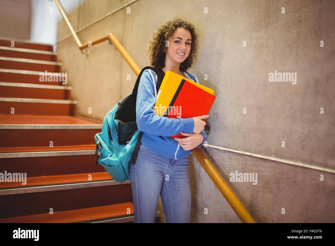 Pretty student walking down steps Stock Photo - Alamy