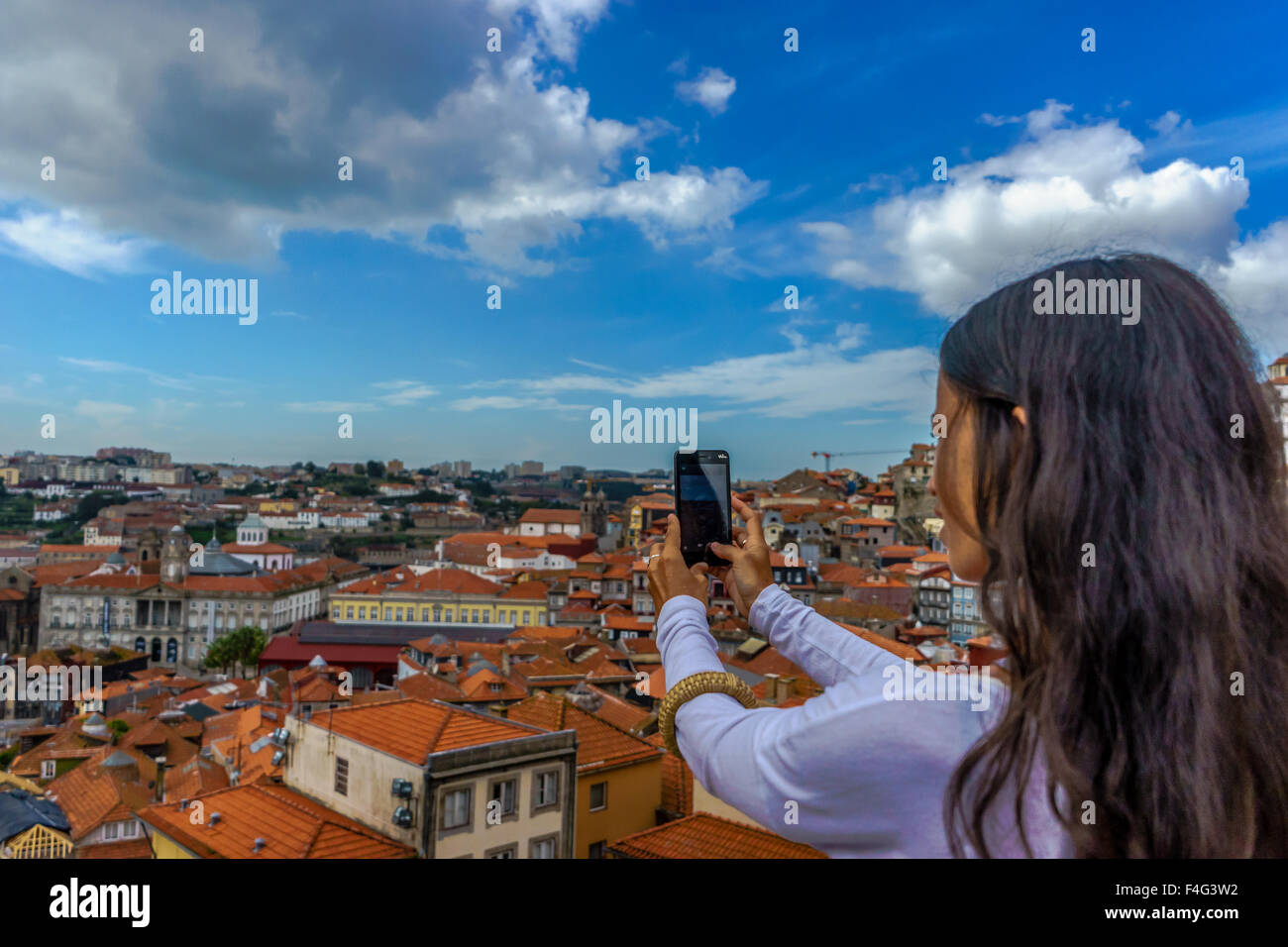 Beautiful Portuguese woman takes a picture of old town Porto with a ...
