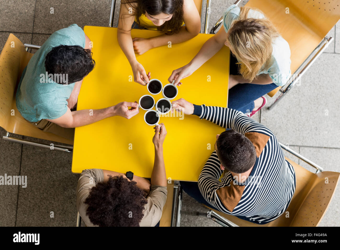Students toasting with coffee in cafe Stock Photo - Alamy