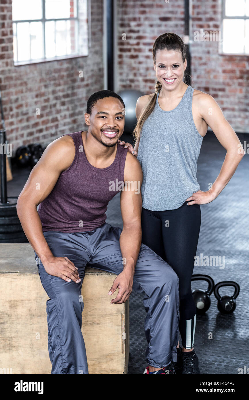 Smiling fit couple posing together Stock Photo - Alamy