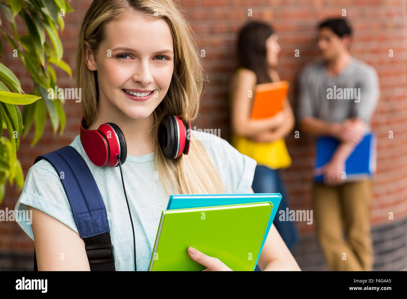 Student smiling at camera outside Stock Photo - Alamy