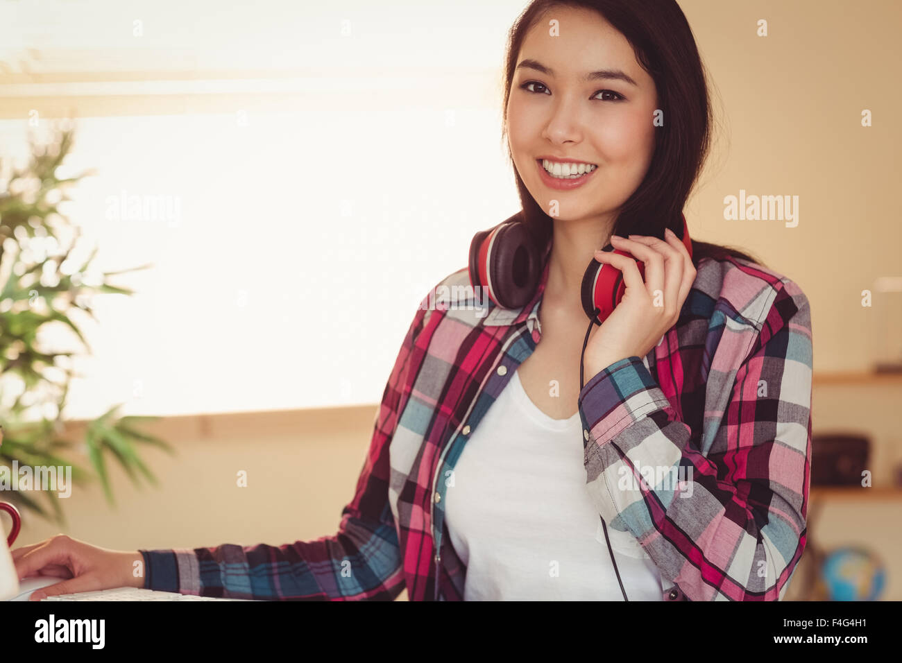 Young creative woman smiling at the camera Stock Photo - Alamy