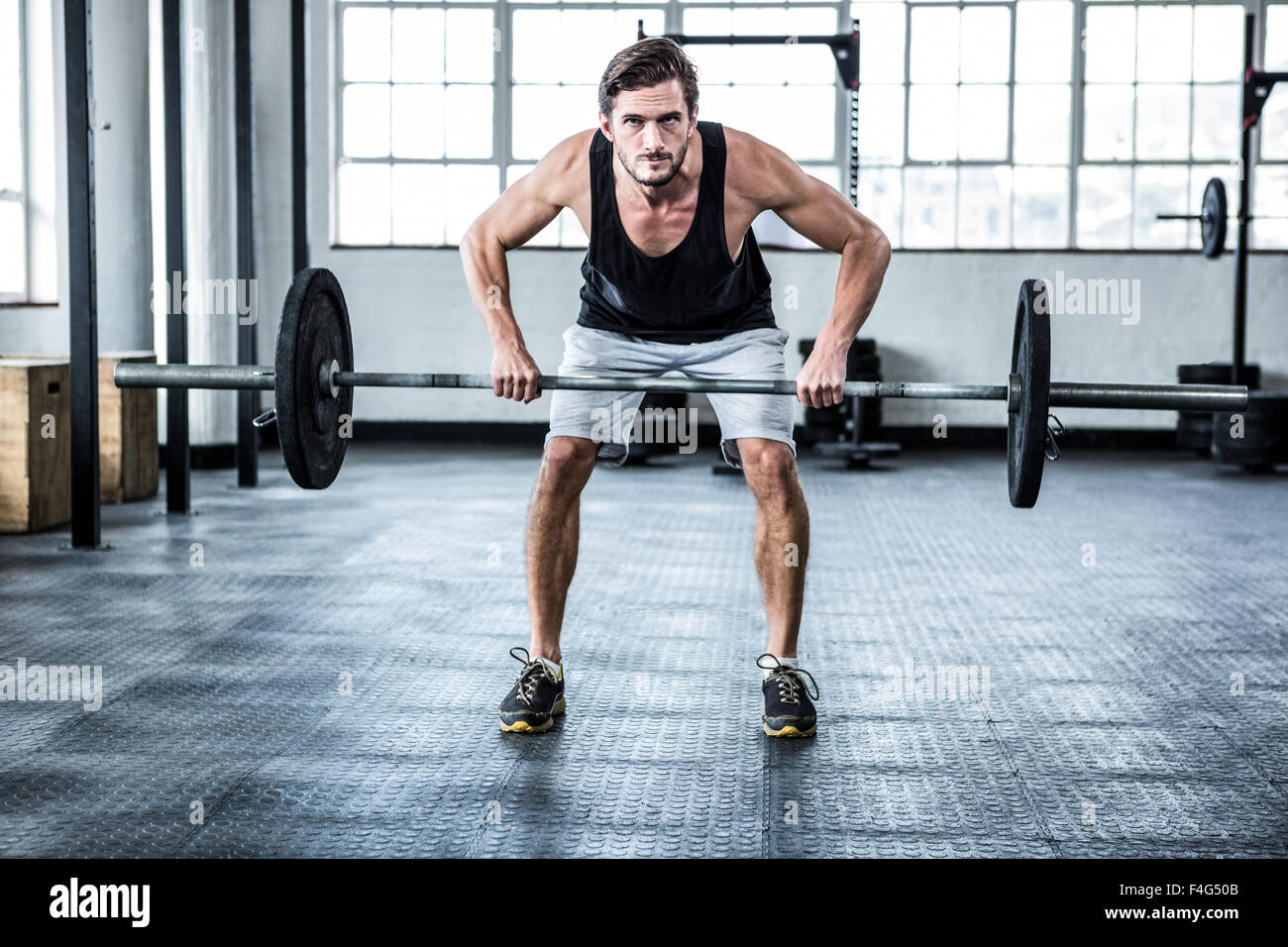 Fit man lifting heavy barbell Stock Photo - Alamy