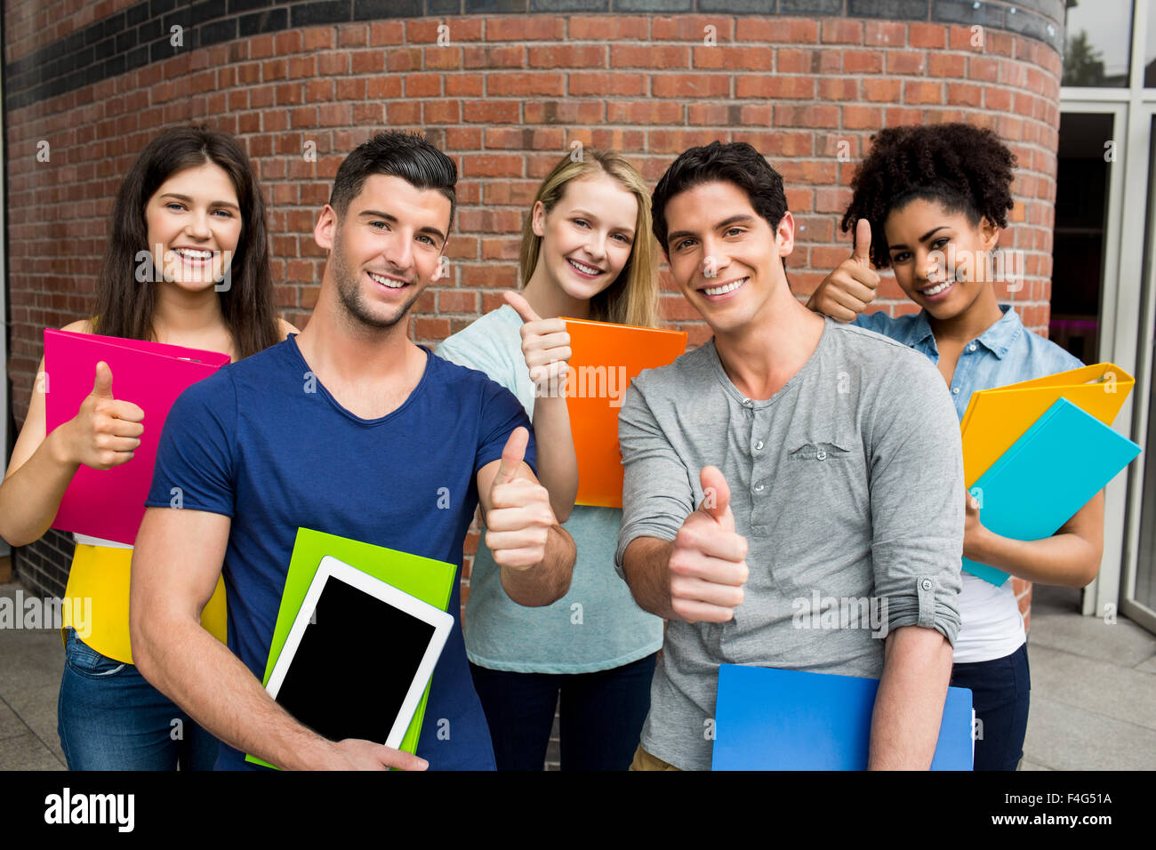 Students smiling at the camera Stock Photo - Alamy