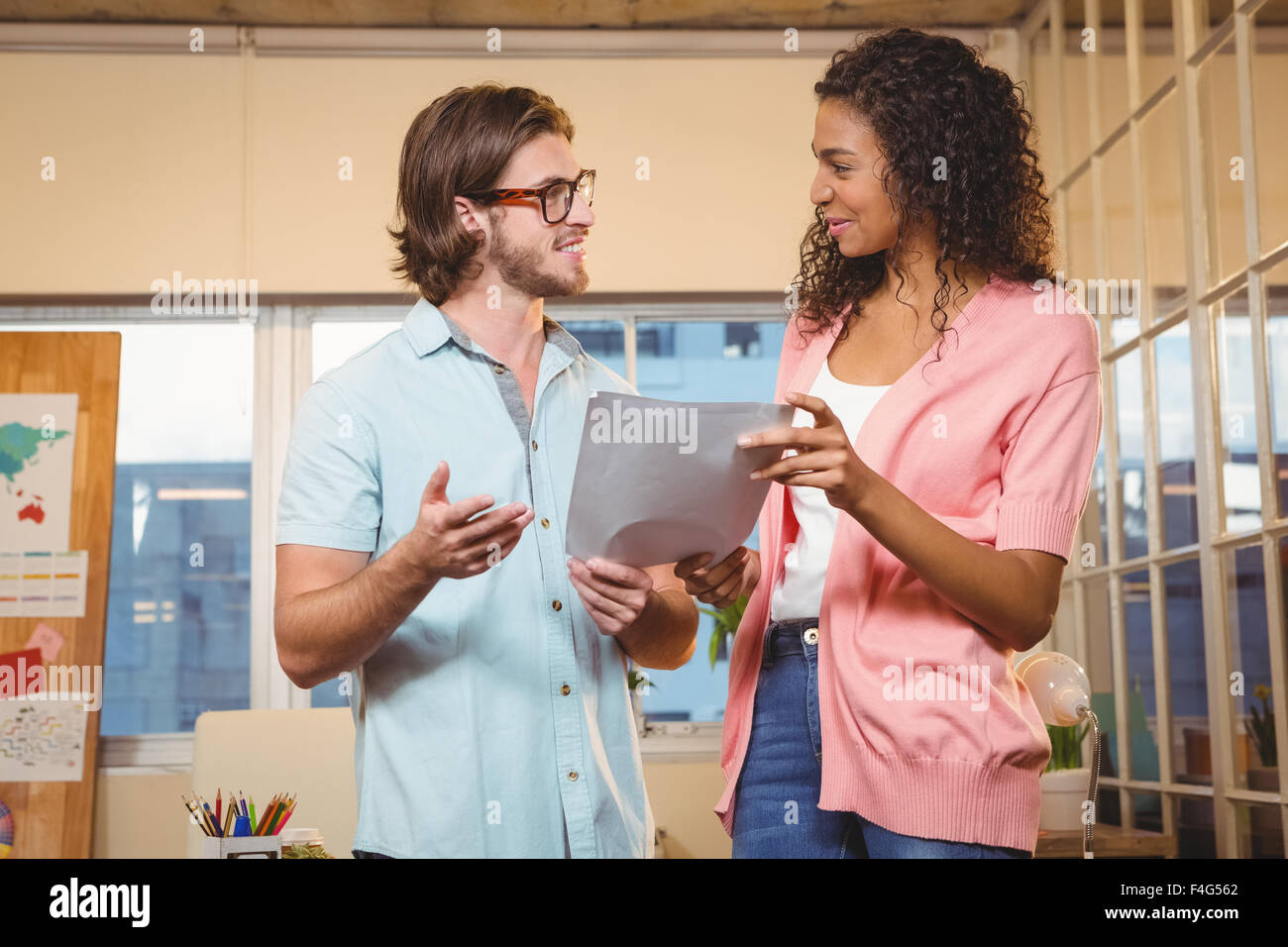 Happy business people discussing over document Stock Photo - Alamy