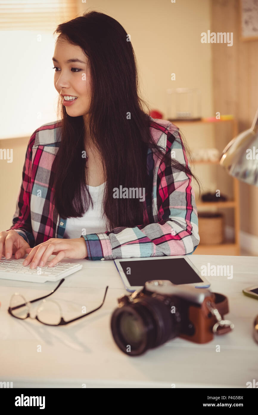 Young creating woman typing on keyboard Stock Photo - Alamy
