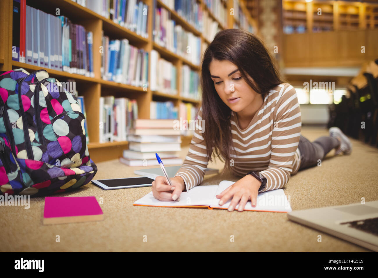 Student lying on library floor hi-res stock photography and images - Alamy