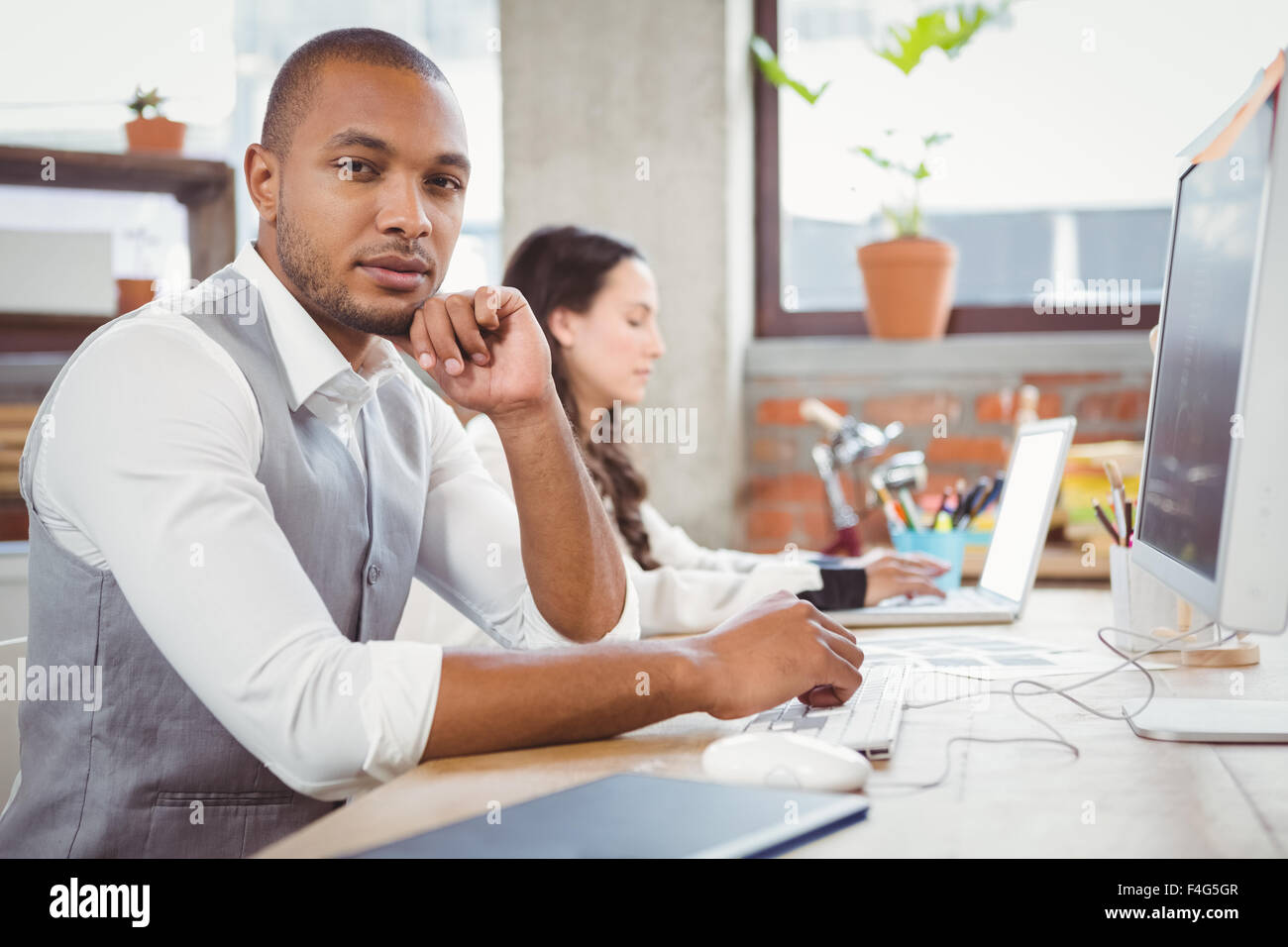 Man posing when colleague working Stock Photo - Alamy