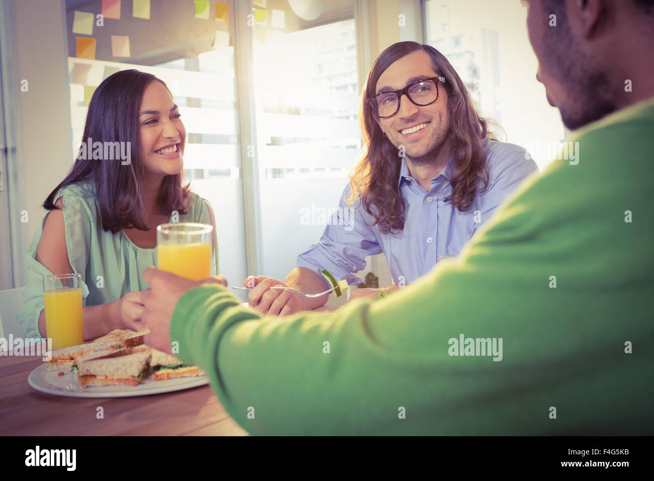Creative business people having breakfast in office Stock Photo - Alamy
