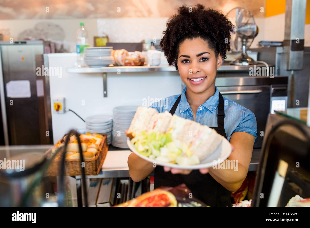 Pretty waitress serving lunch to camera Stock Photo - Alamy