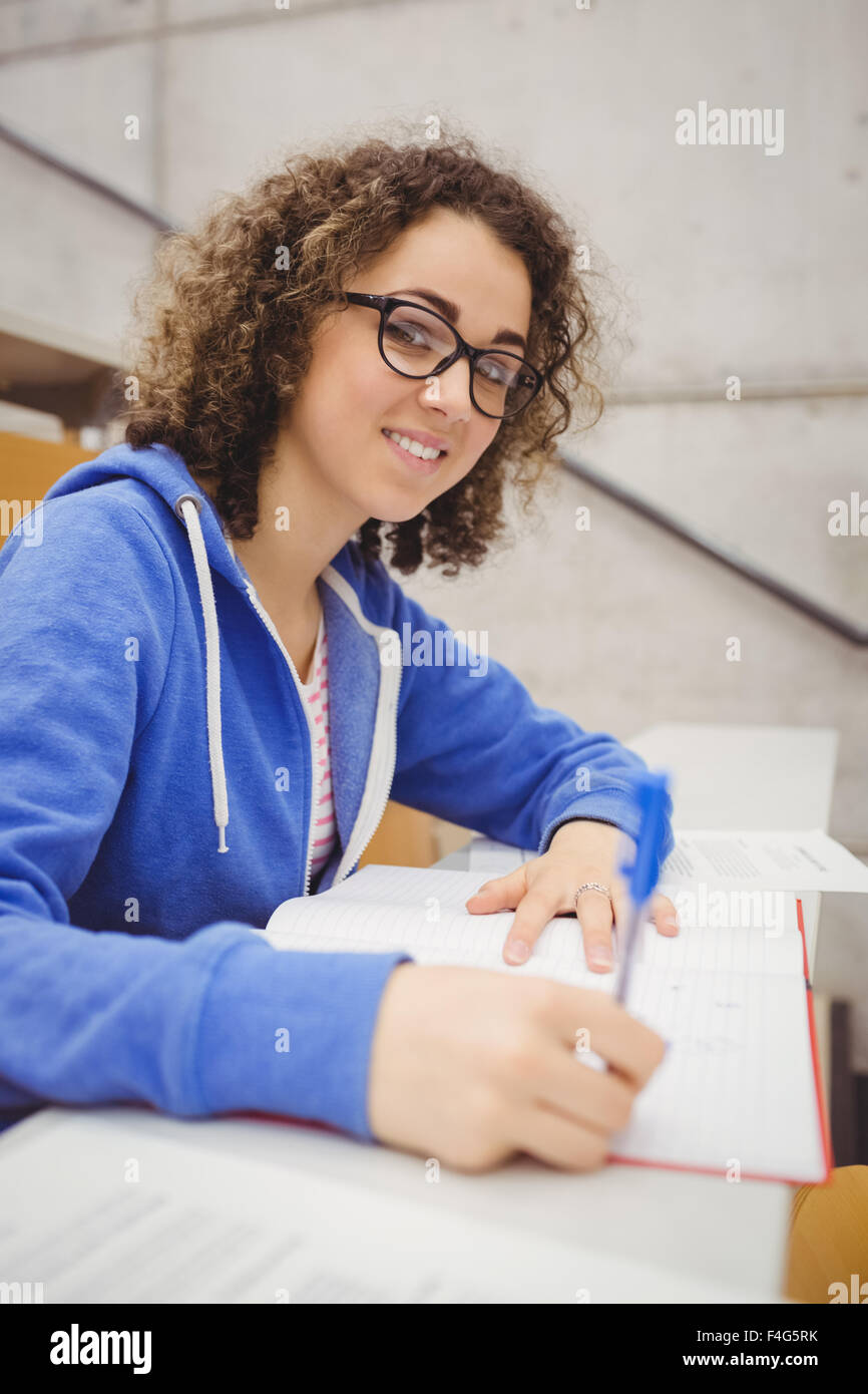 Happy student taking notes in lecture Stock Photo - Alamy