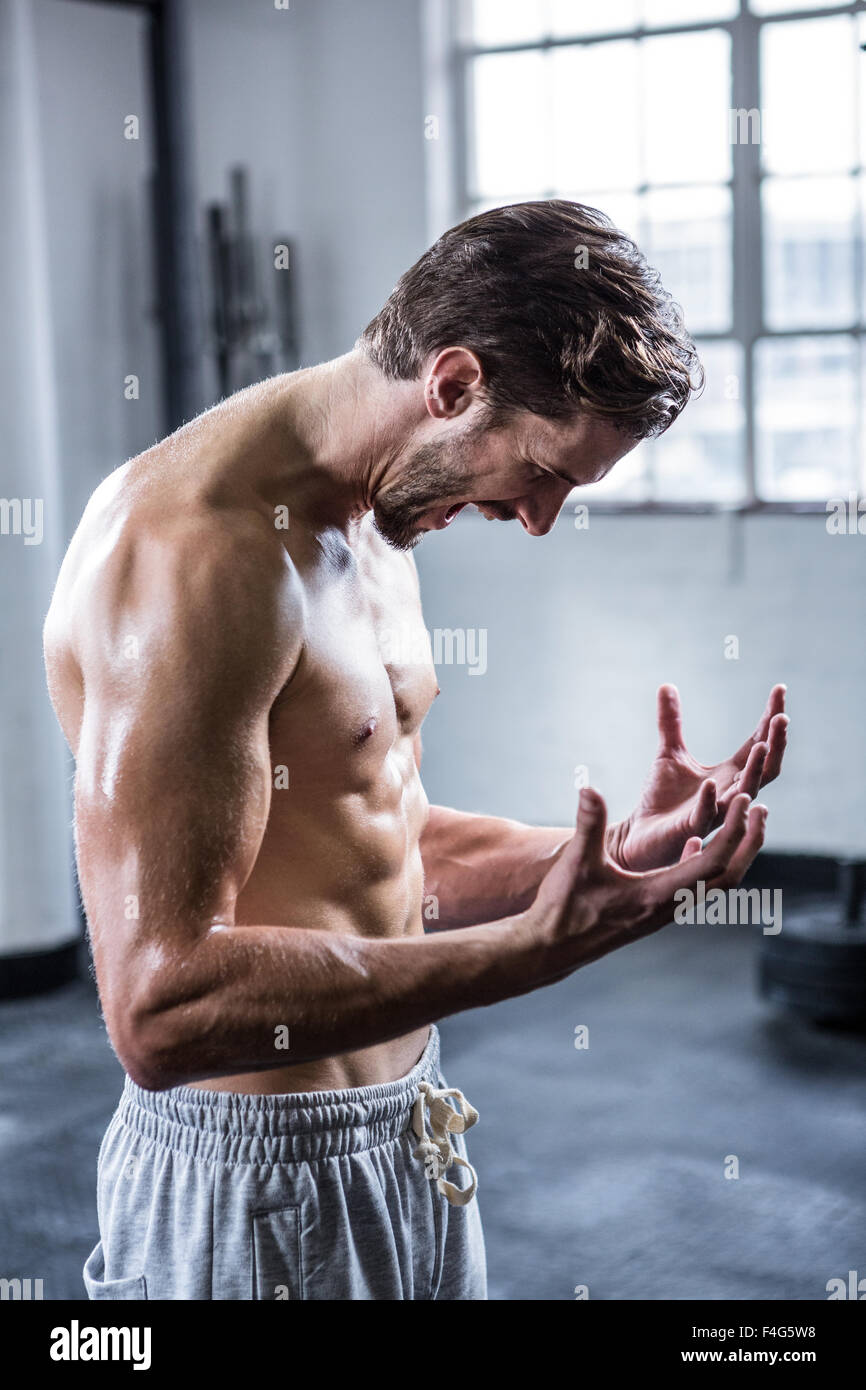 Fit shirtless man shouting and flexing Stock Photo - Alamy
