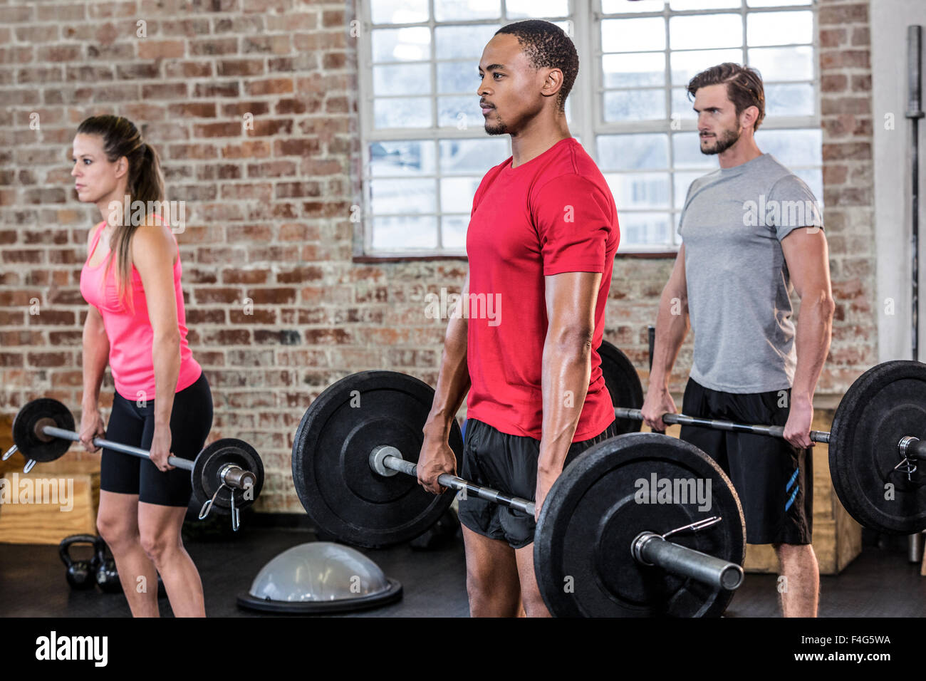 Fit people lifting barbell weight Stock Photo - Alamy