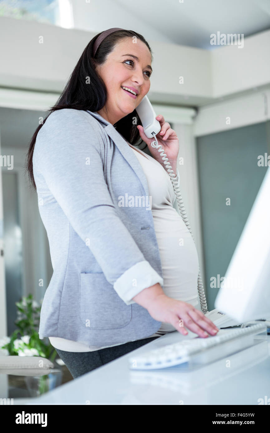 Pregnant businesswoman having a phone call Stock Photo - Alamy