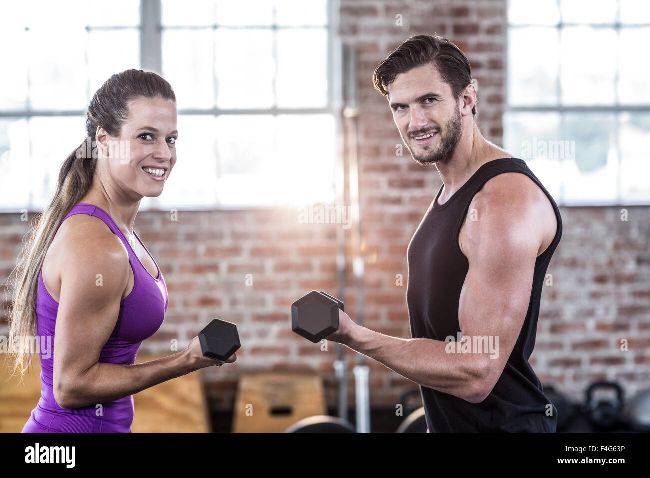 Fit people doing dumbbell exercises Stock Photo - Alamy