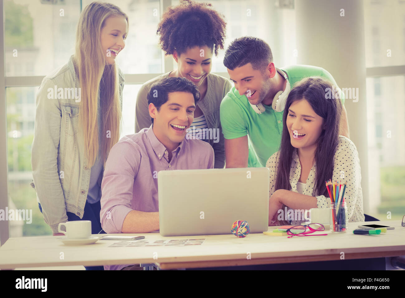 Students working together on laptop Stock Photo - Alamy
