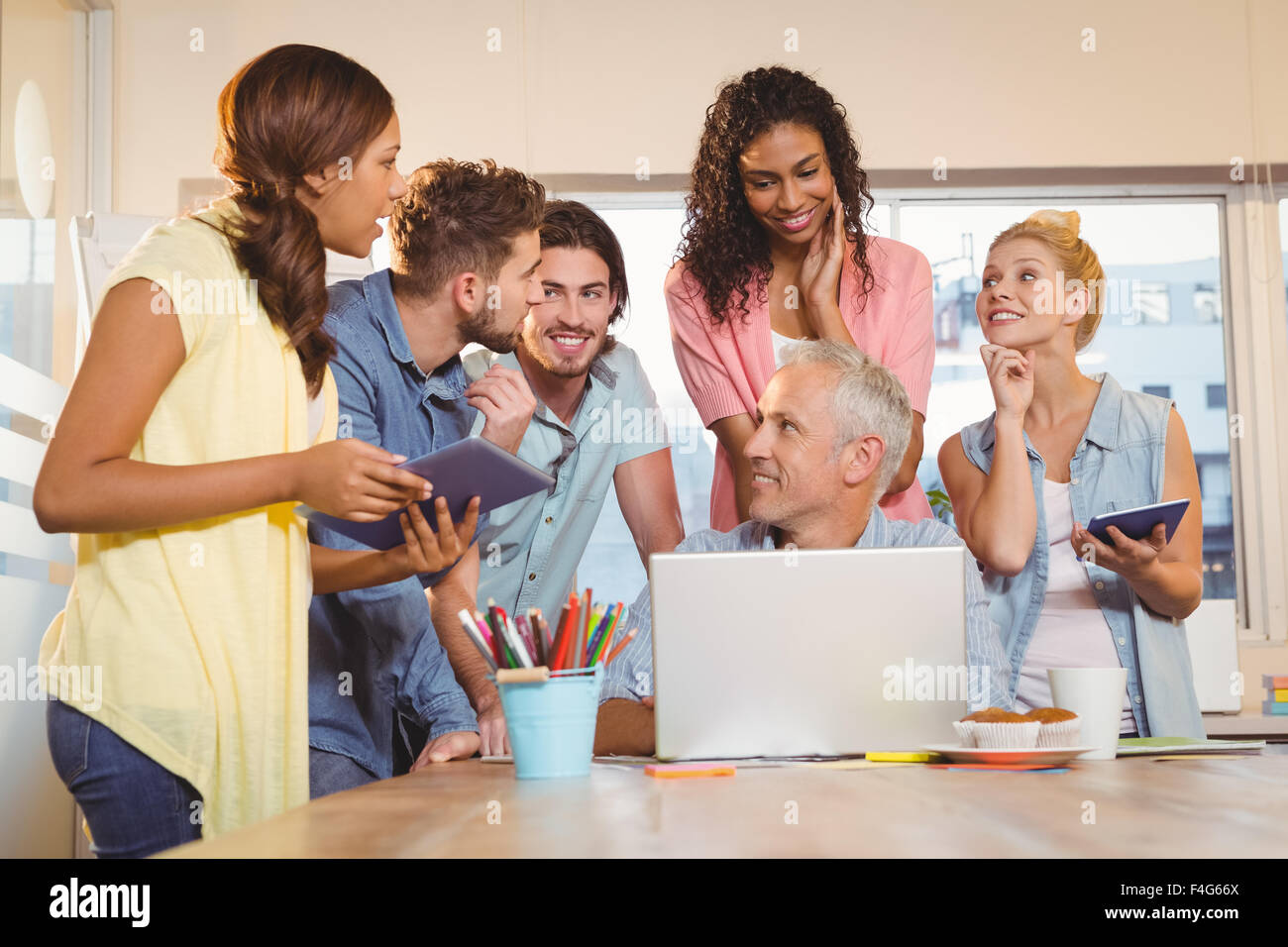 Business people using technologies while discussion during meeting ...