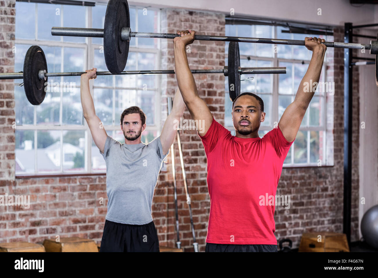 Fit people lifting a barbell Stock Photo - Alamy